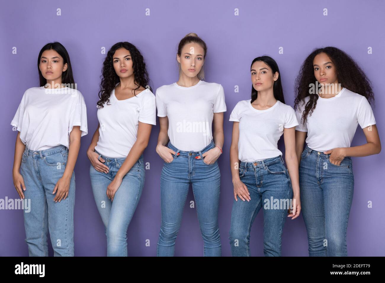 Five Serious Multicultural Ladies Standing Together Over Purple ...