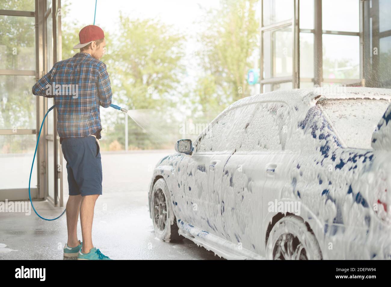 male driver cleaning the car inside the self wash station box Stock ...