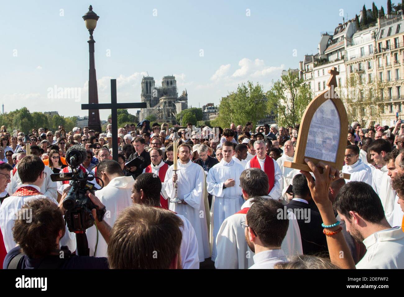 Cross is carry by archbishop of Paris near Notre Dame during the ...