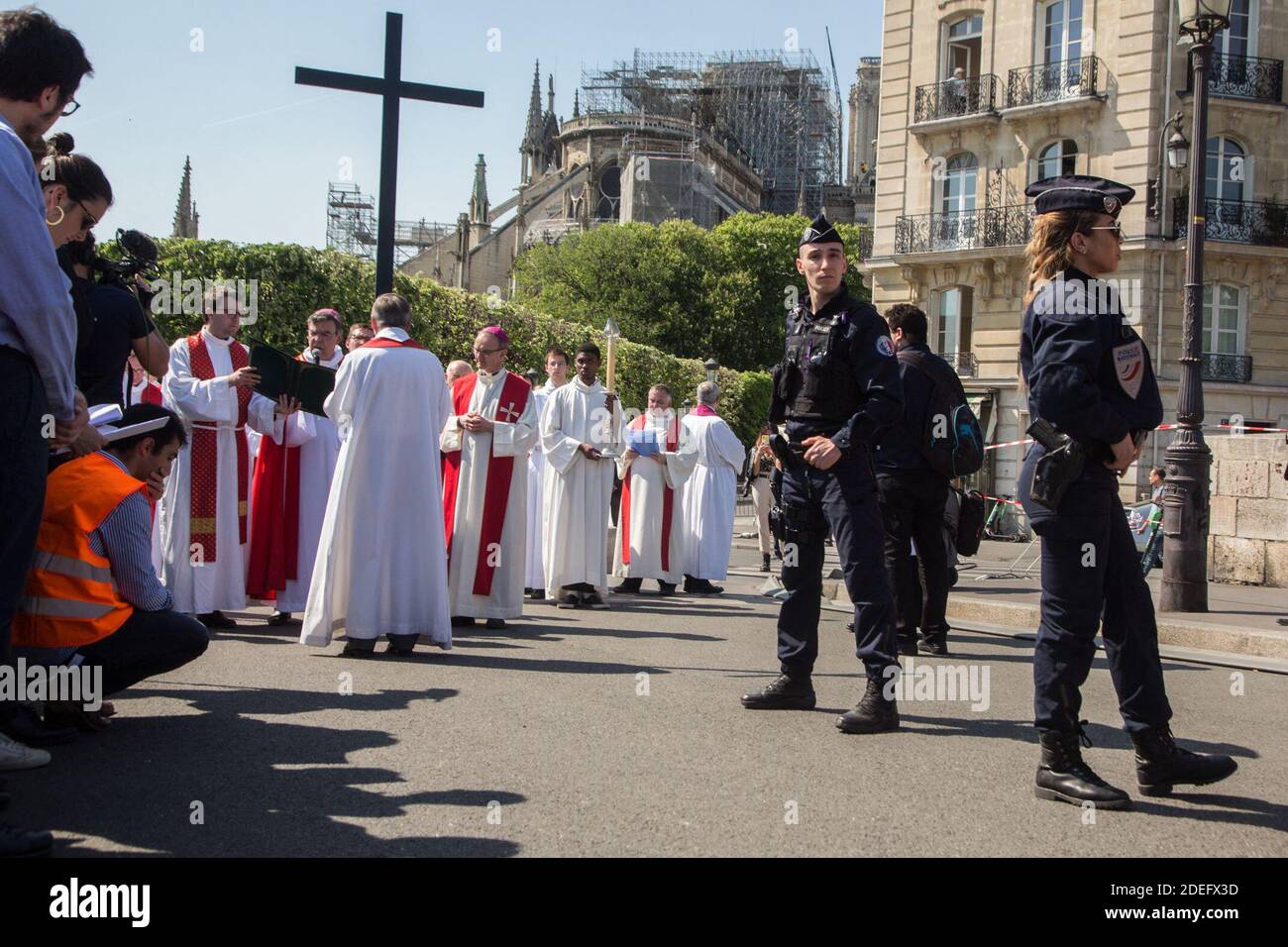 Cross is carry by archbishop of Paris near Notre Dame during the ...