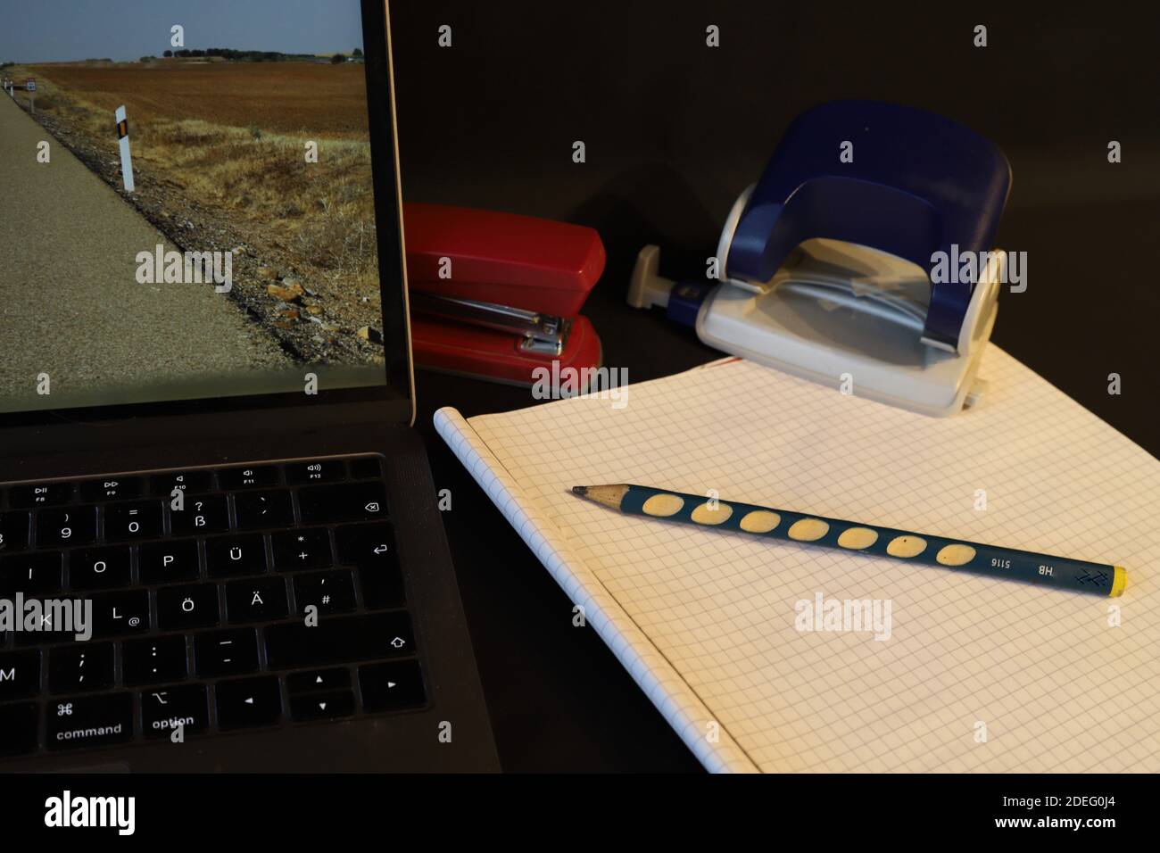 desk with laptop, paper and pencil Stock Photo - Alamy