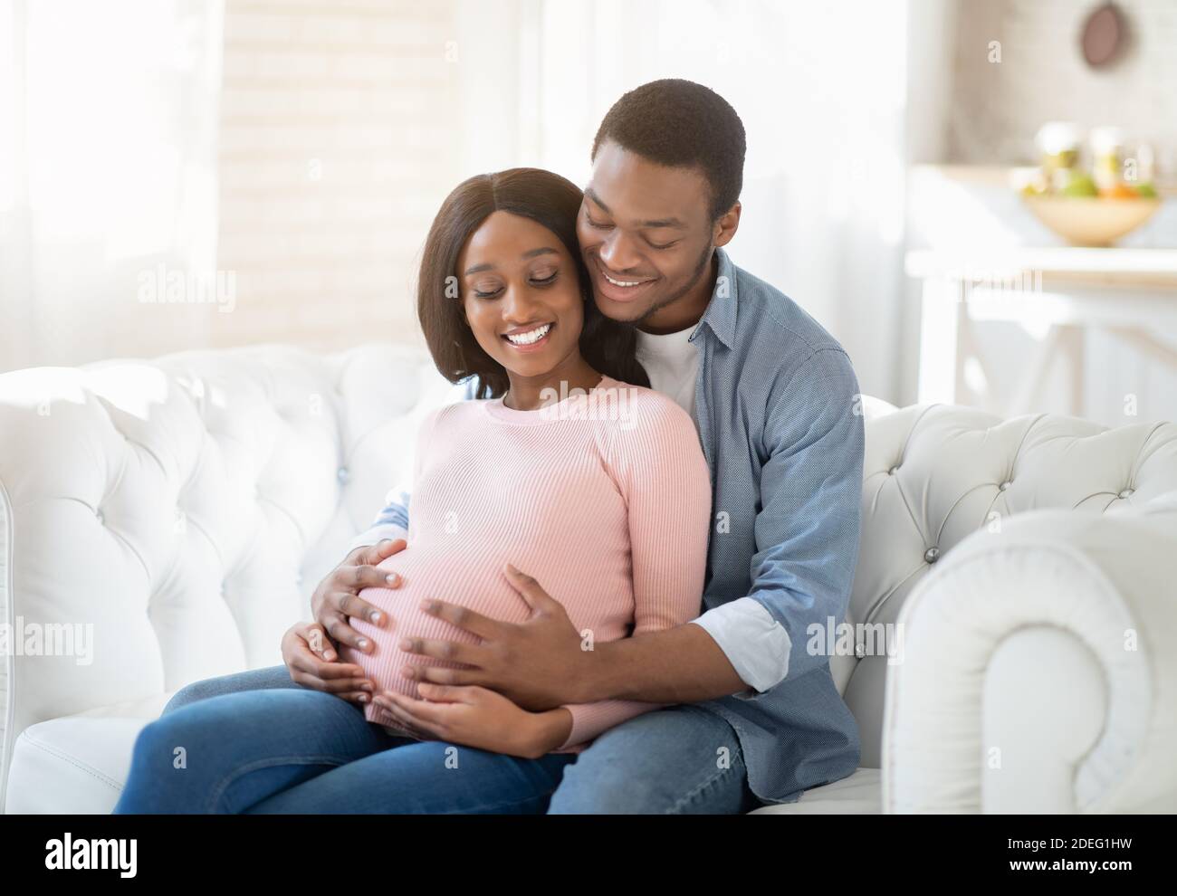 Pregnancy mom dad hugging belly hi-res stock photography and images - Alamy