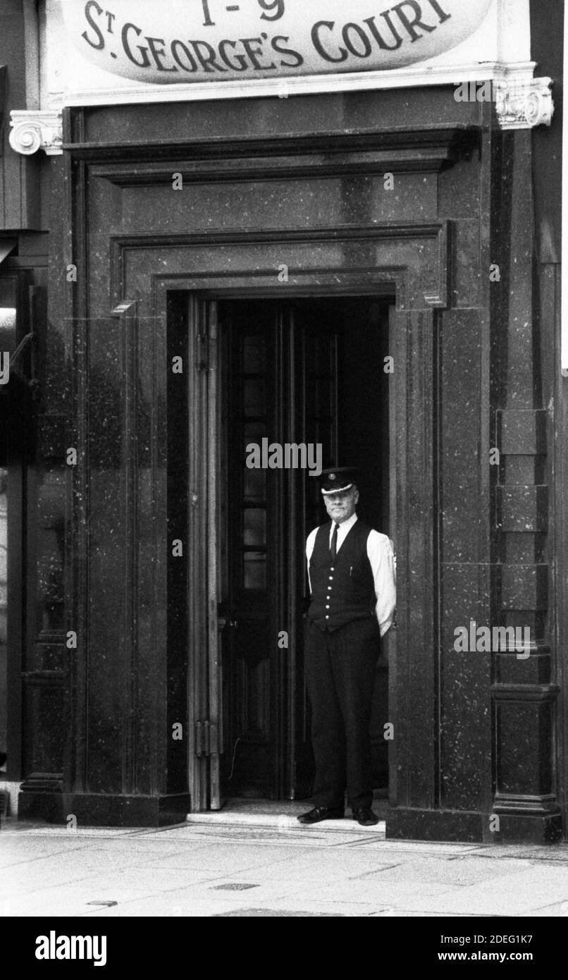 Concierge stand before the gate at St George's court, London, 1971 ...
