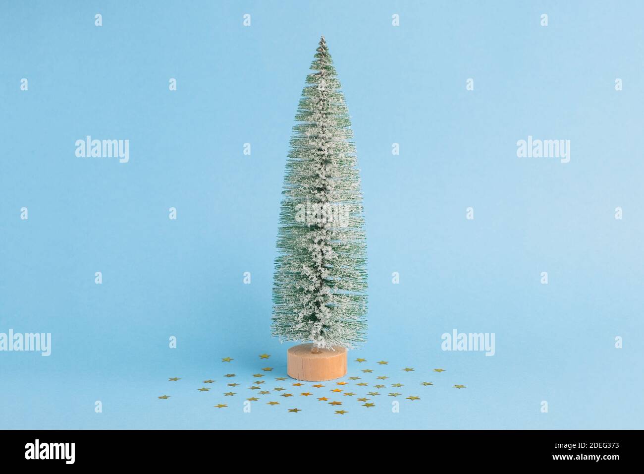 Christmas snowy tree and on pastel blue background. Minimal New year ...