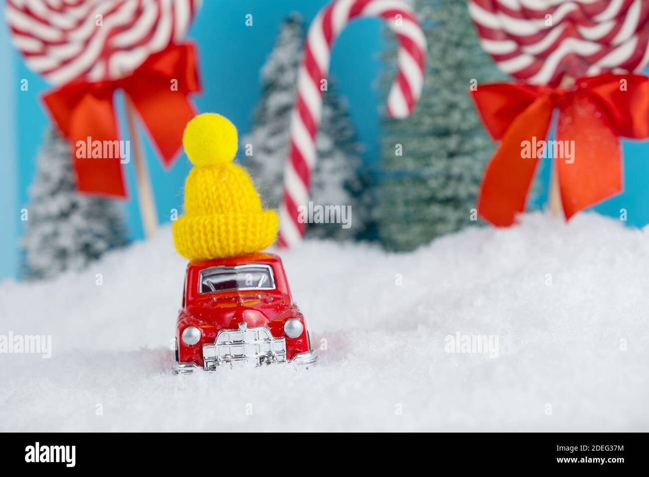 Red Santa car with in yellow winter cap and Christmas tree forest with ...