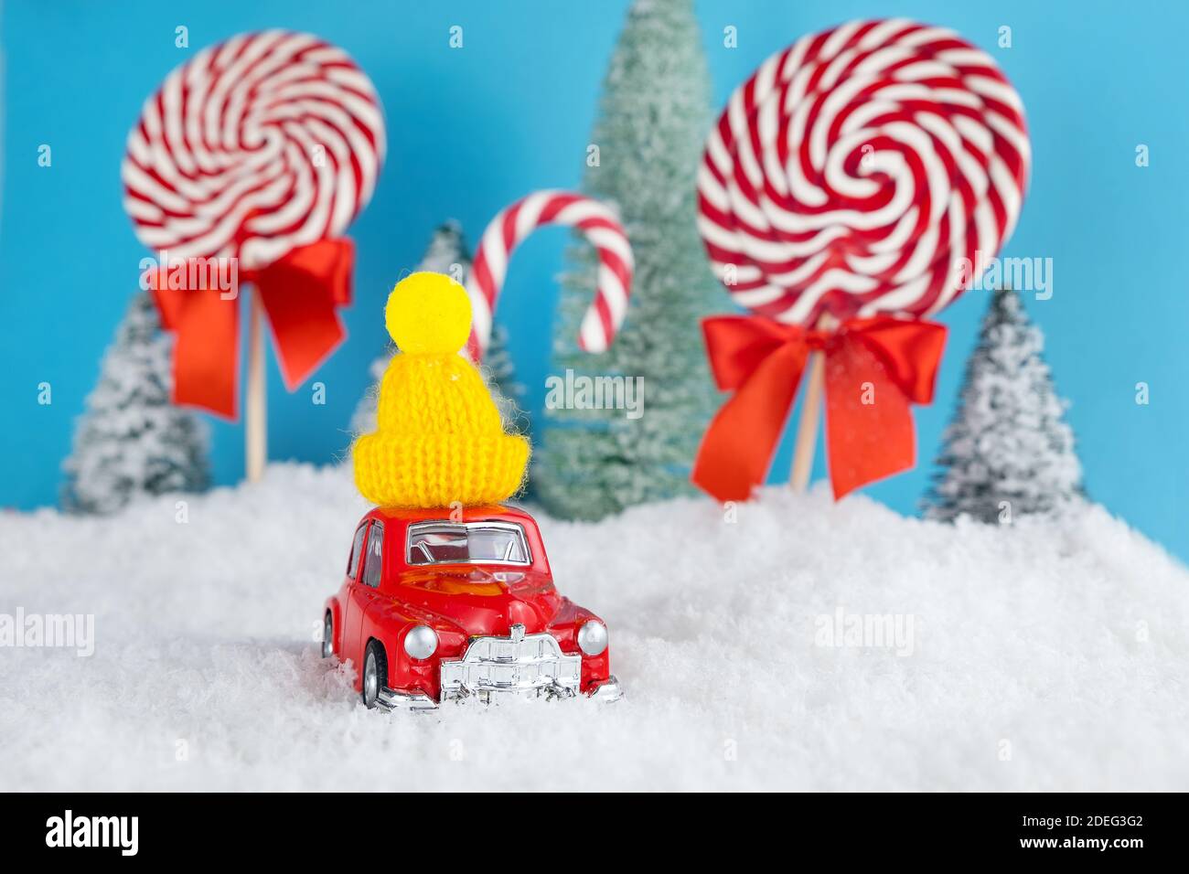 Red Santa car with in yellow winter cap and Christmas tree forest with ...