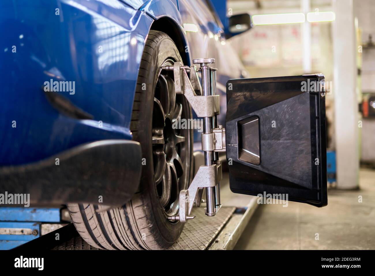 car in service with sensors on the wheels to check alignment camber toe ...
