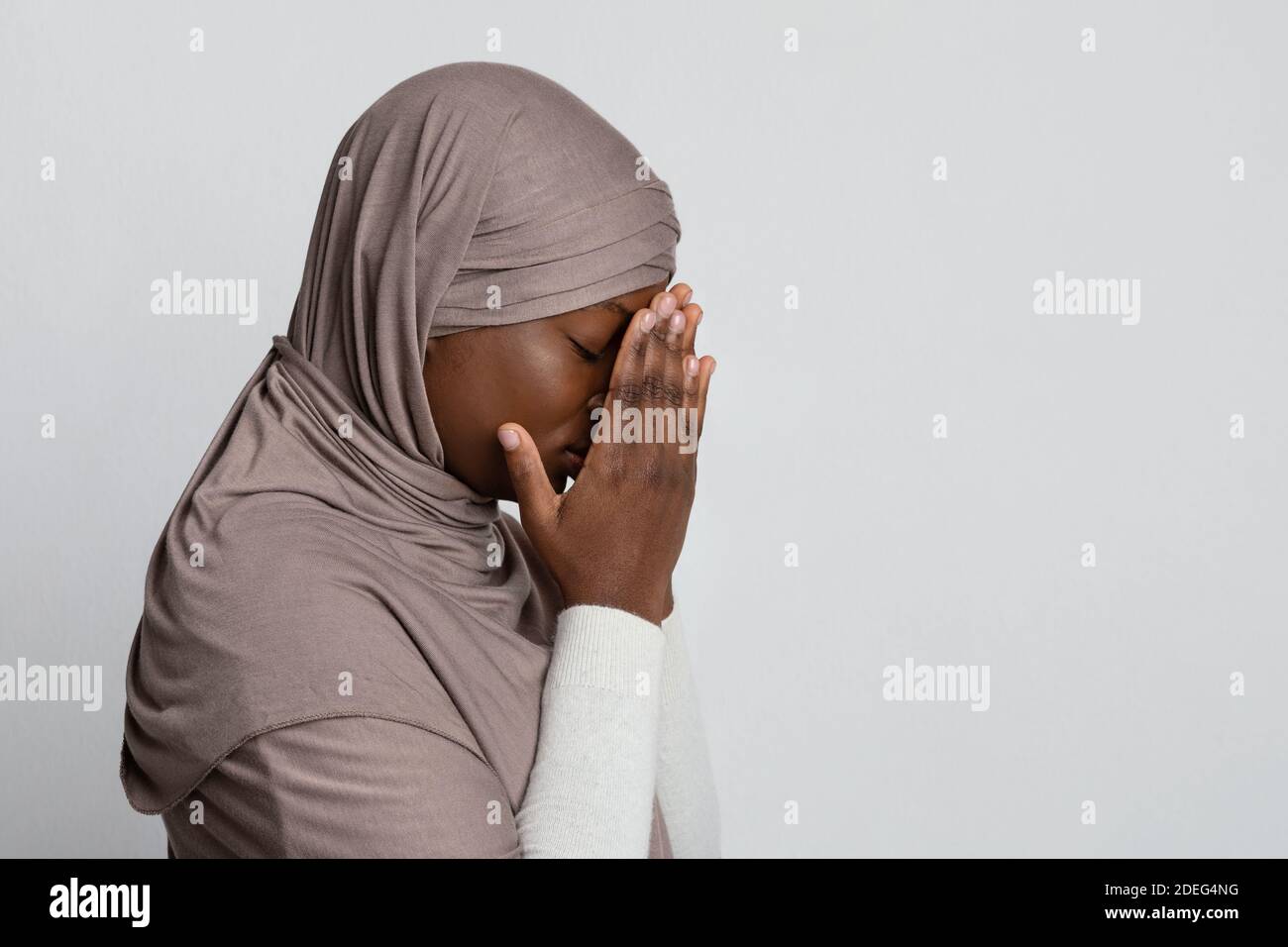 Profile portrait of sad crying black muslim woman in hijab covering ...