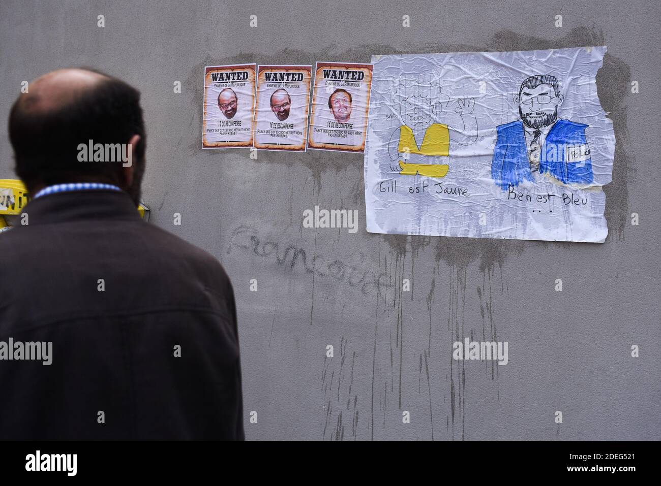 A man looks to a sign during the annual may day protests in Paris on ...