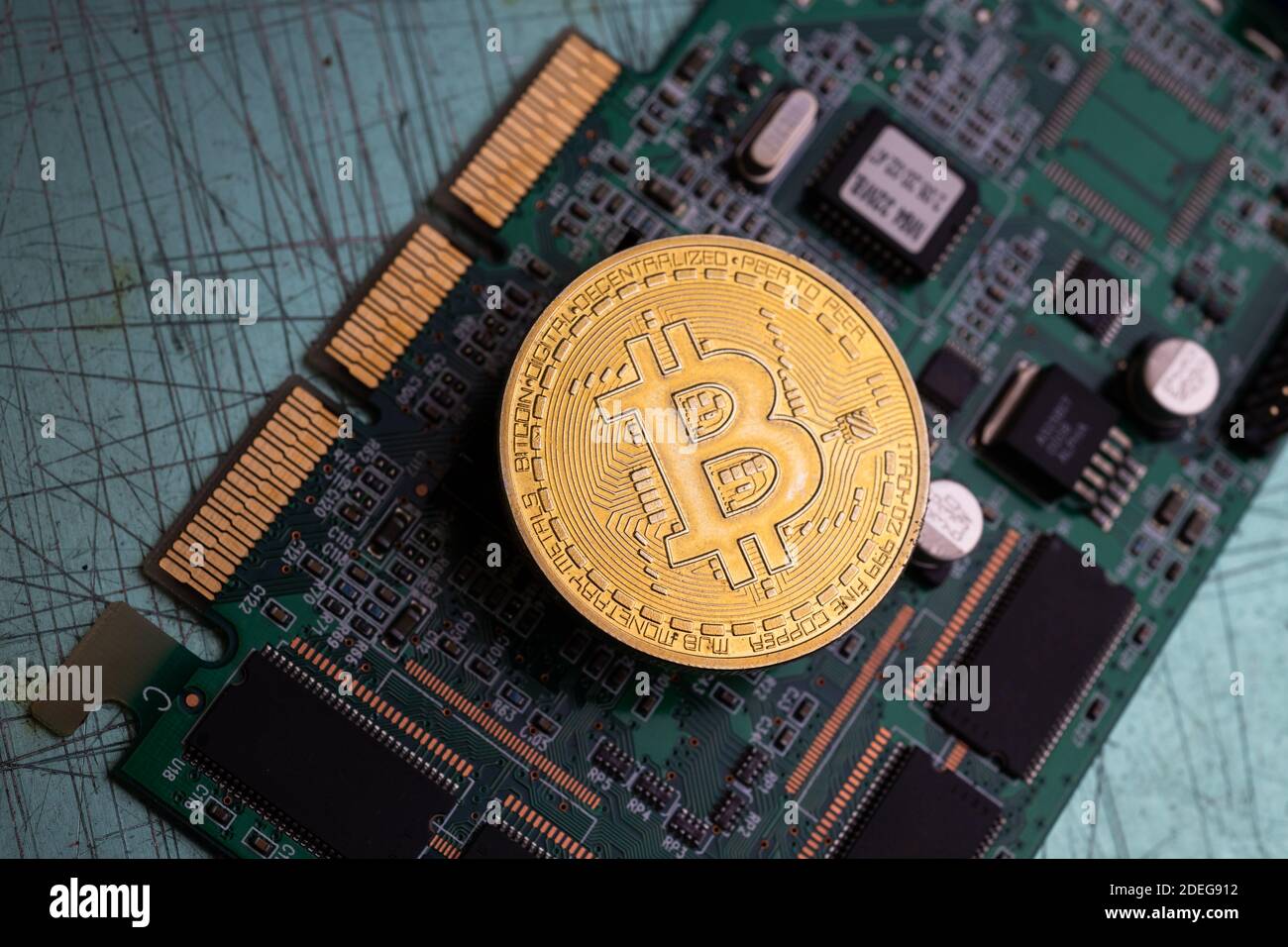 Bitcoin token on top of computer circuit board background Stock Photo ...