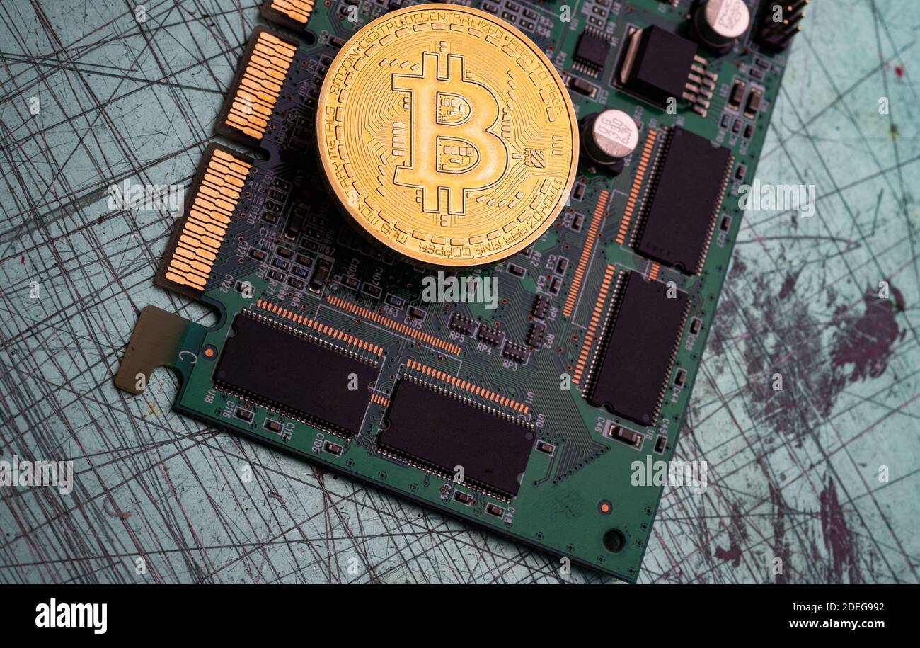 Bitcoin token on top of computer circuit board background Stock Photo ...