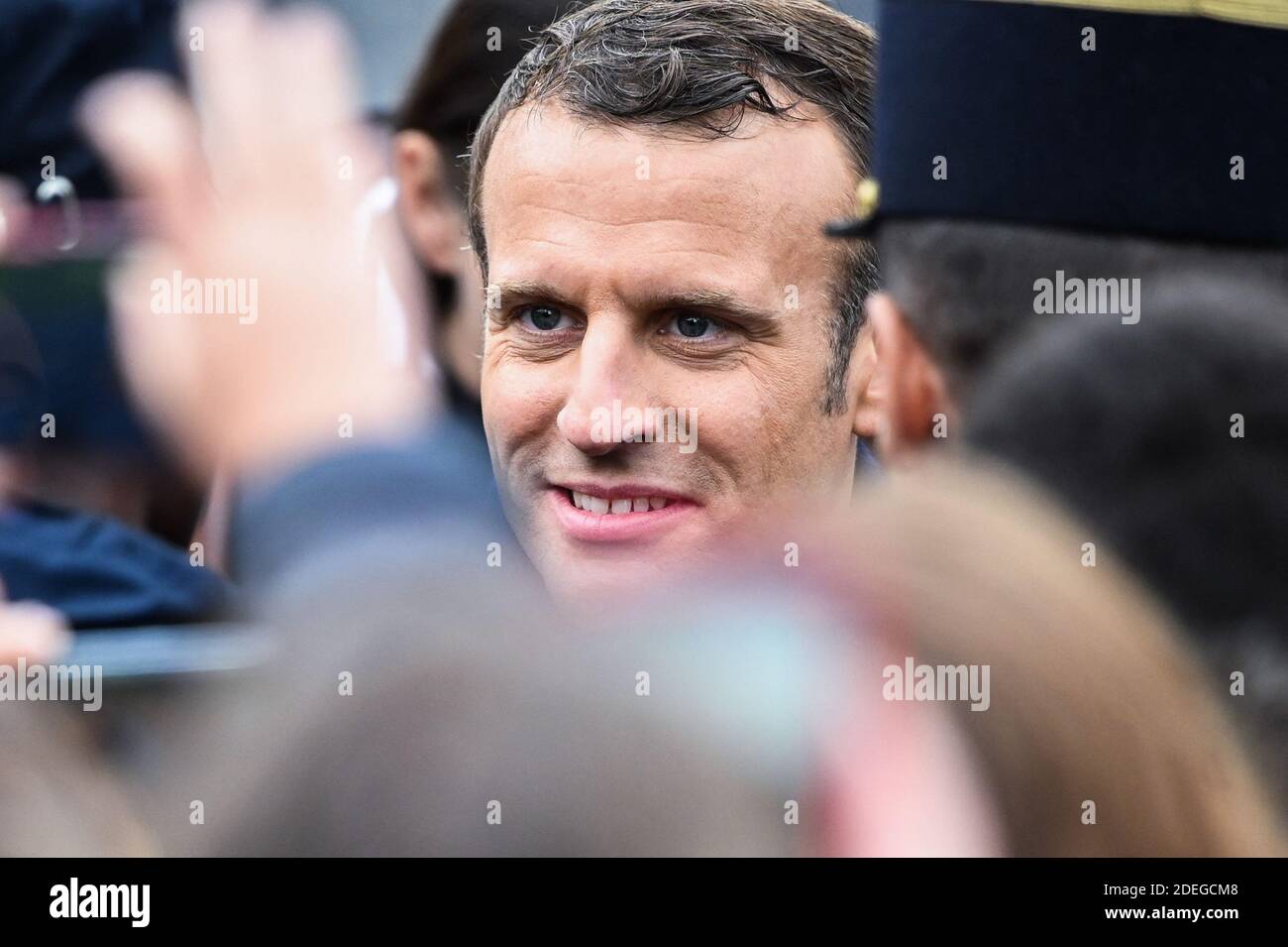 French President Emmanuel Macron smiles during a wreath laying ceremony ...