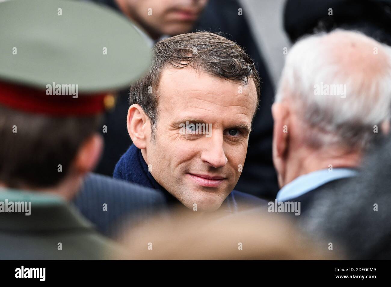 French President Emmanuel Macron smiles during a wreath laying ceremony ...