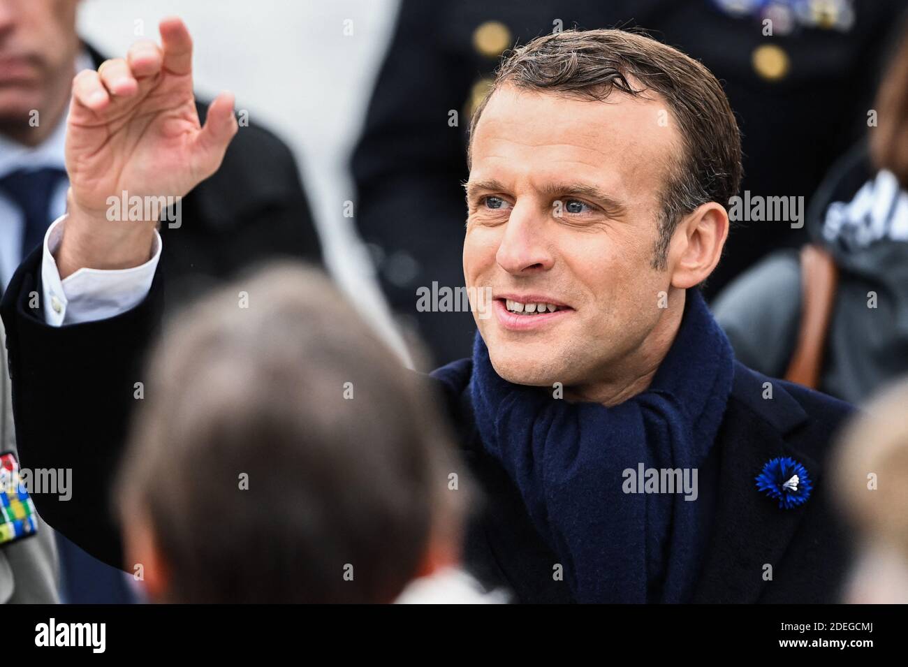 French President Emmanuel Macron smiles during a wreath laying ceremony ...
