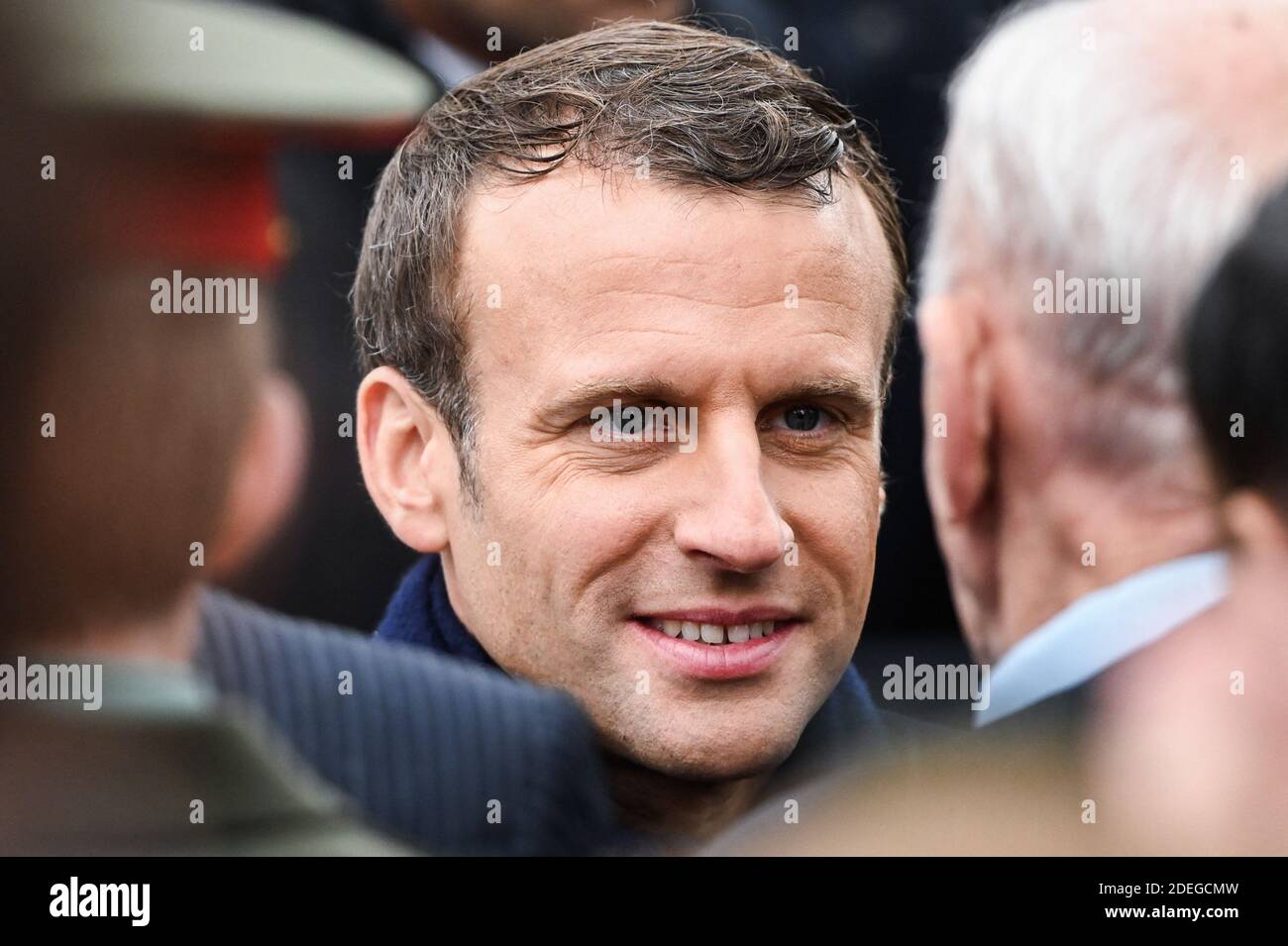 French President Emmanuel Macron smiles during a wreath laying ceremony ...