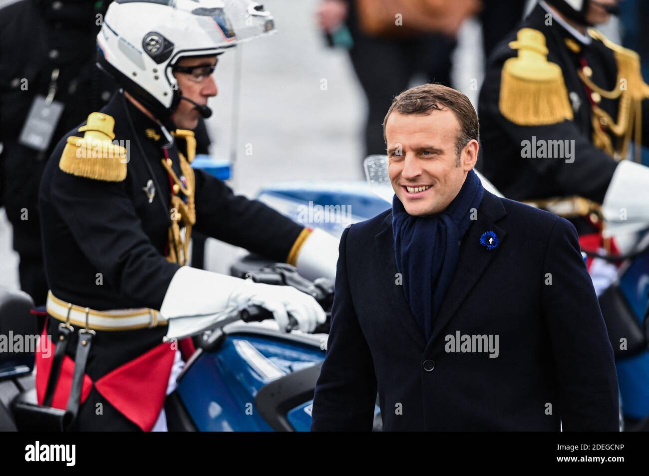 French President Emmanuel Macron smiles during a wreath laying ceremony ...