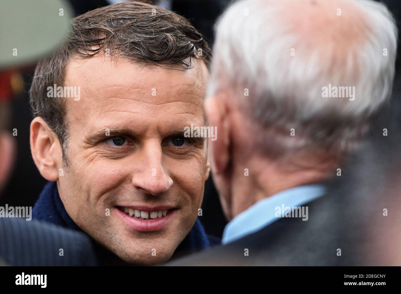 French President Emmanuel Macron smiles during a wreath laying ceremony ...
