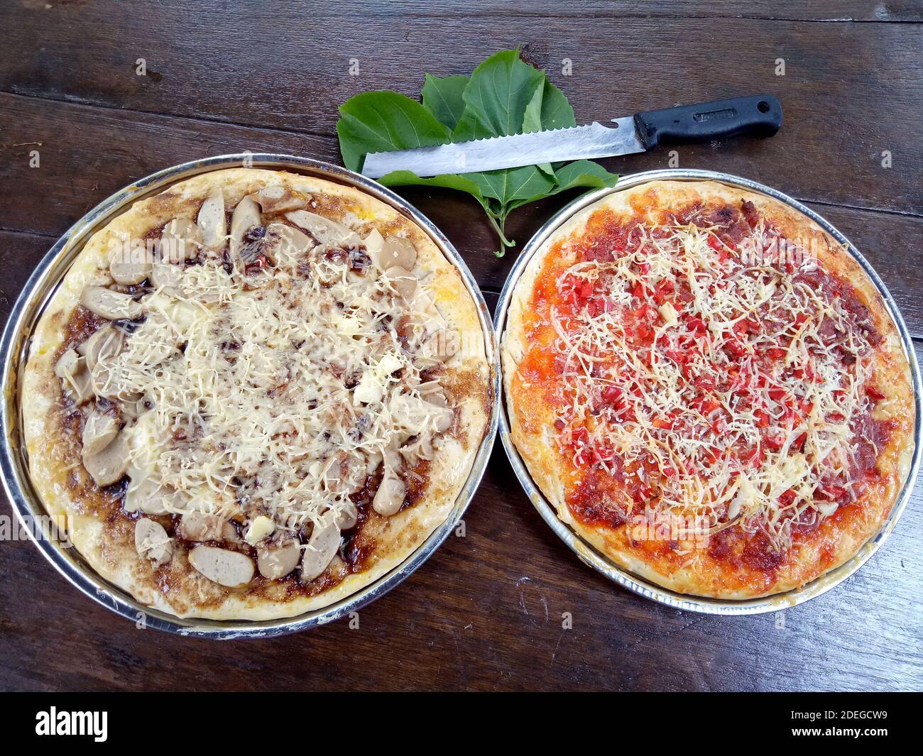 Home Made Pizza on the Wood Table with Banana Leaf and Knife Stock ...