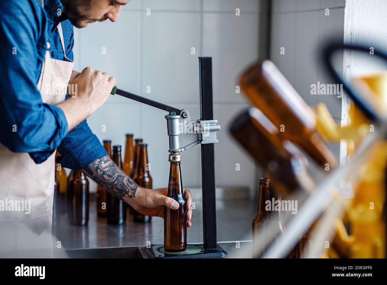 Drink production, employee works on beer manufacturing, craft plant ...