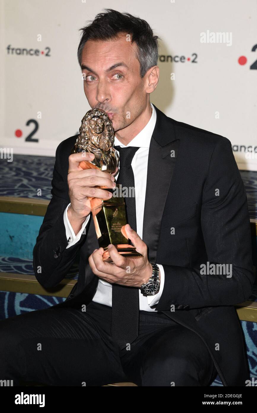 Benoit Soles posing with his award for 'La machine de Turing' during ...