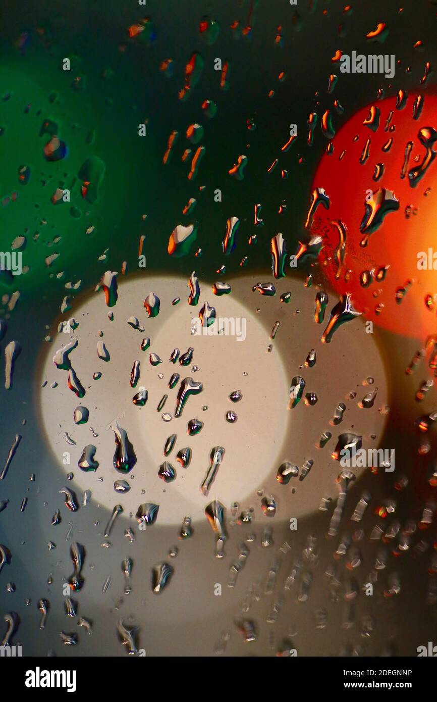 Raindrops on a window at night Stock Photo - Alamy