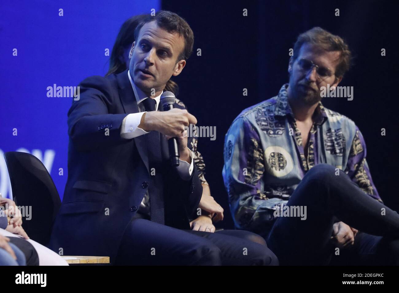 French President Emmanuel Macron (L) takes part in a debate with CEO of ...
