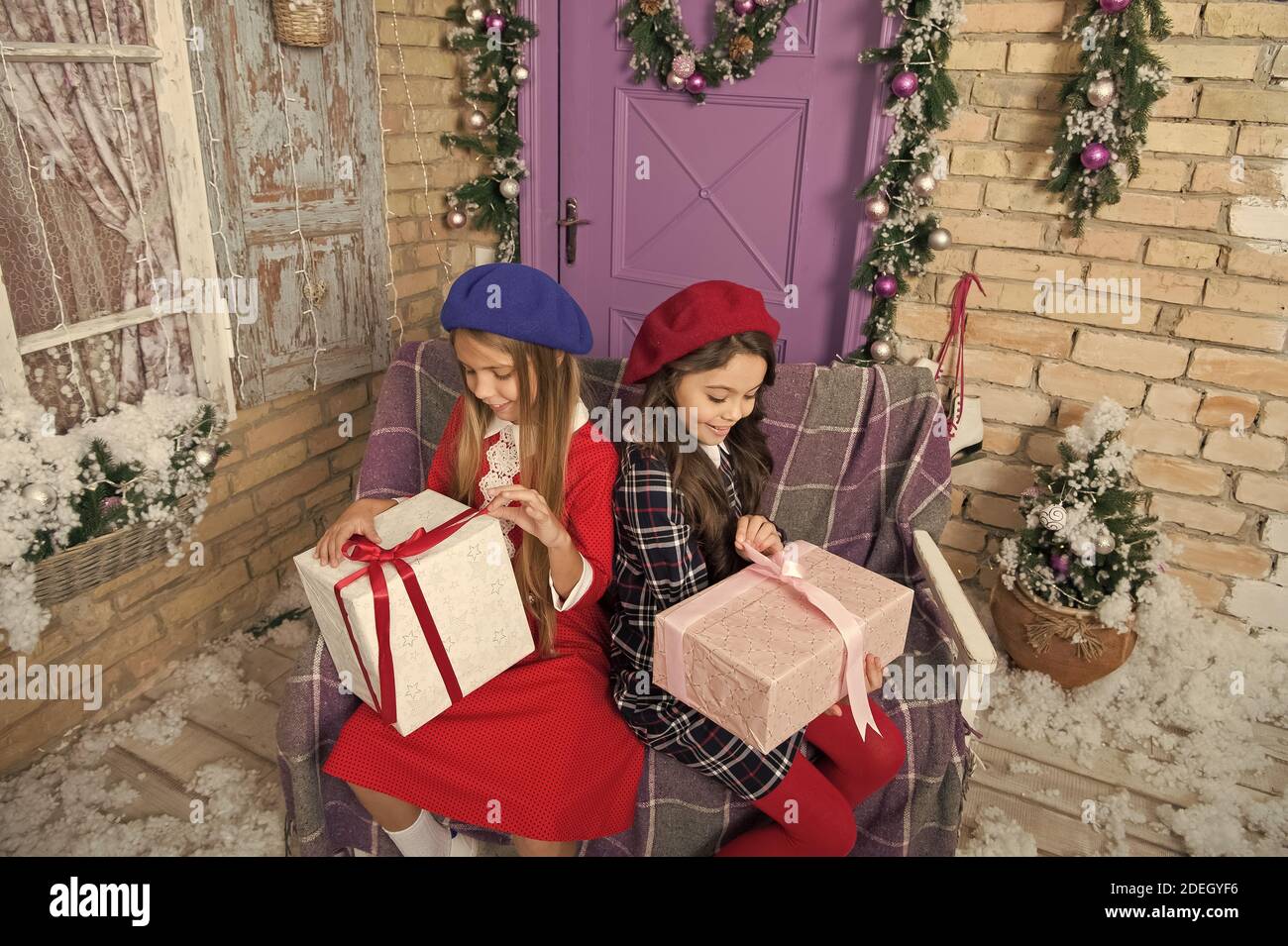 Unwrapping gifts on Christmas morning. Cute children open New Year ...