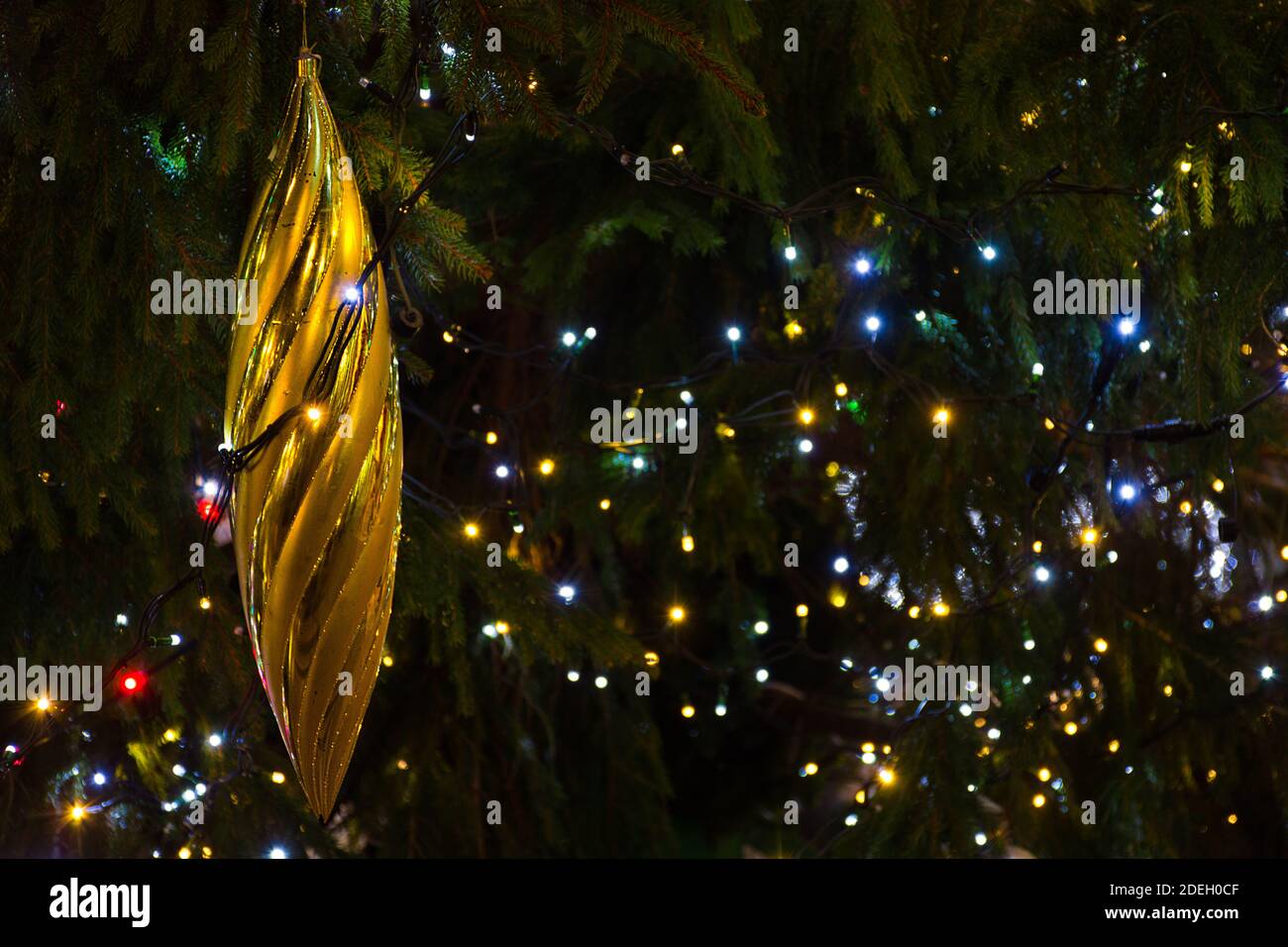 Colorful golden Christmas tree decorations and lights, at night Stock ...