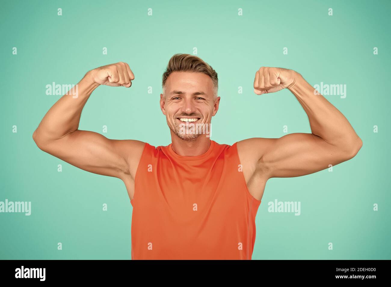 Stay strong in your life. Happy athlete show physical strength. Strong ...