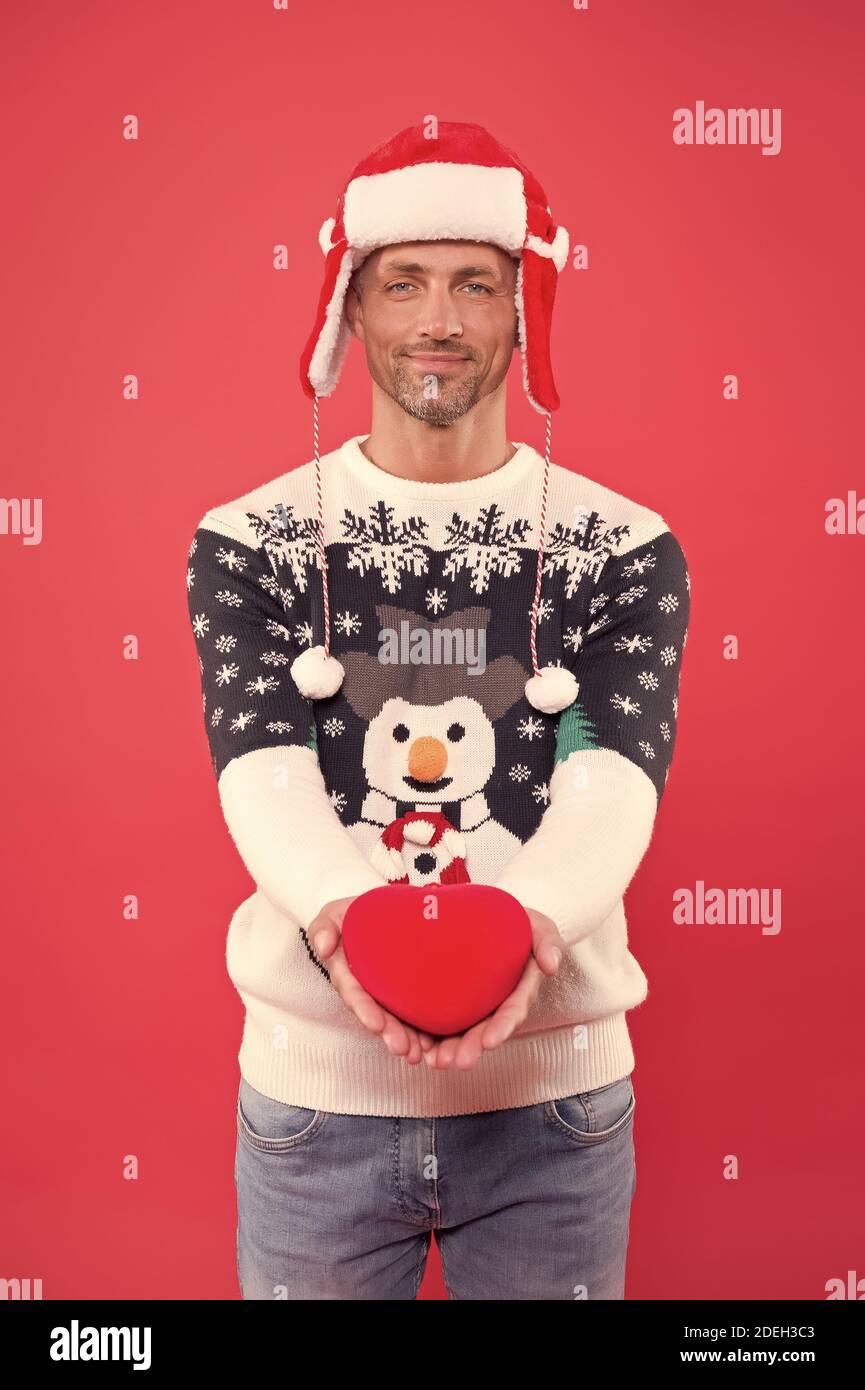 Take my heart. Handsome man hold red heart. Santa man with heart shaped ...