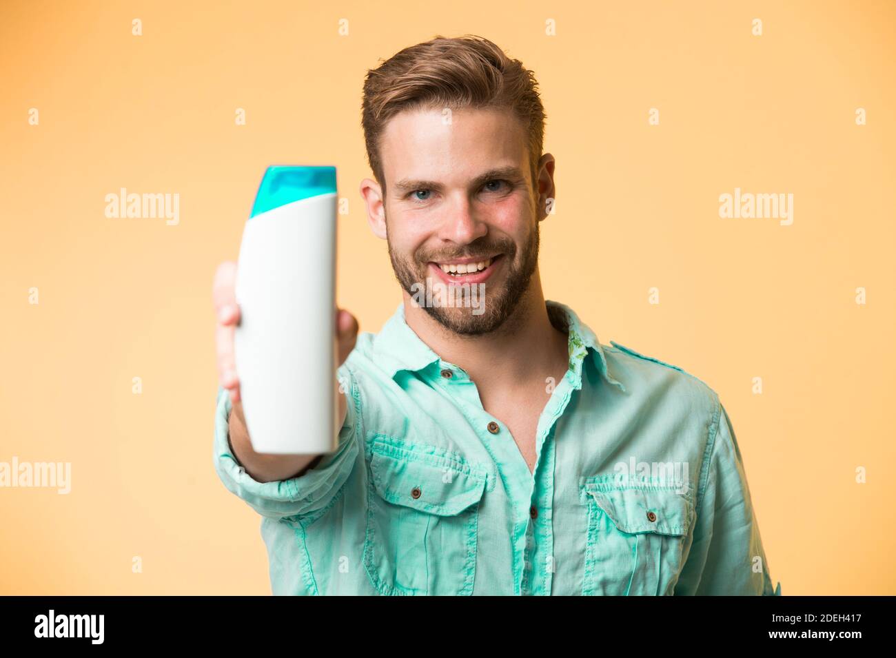 Guy satisfied with this shampoo. Man bearded stylish holds plastic ...