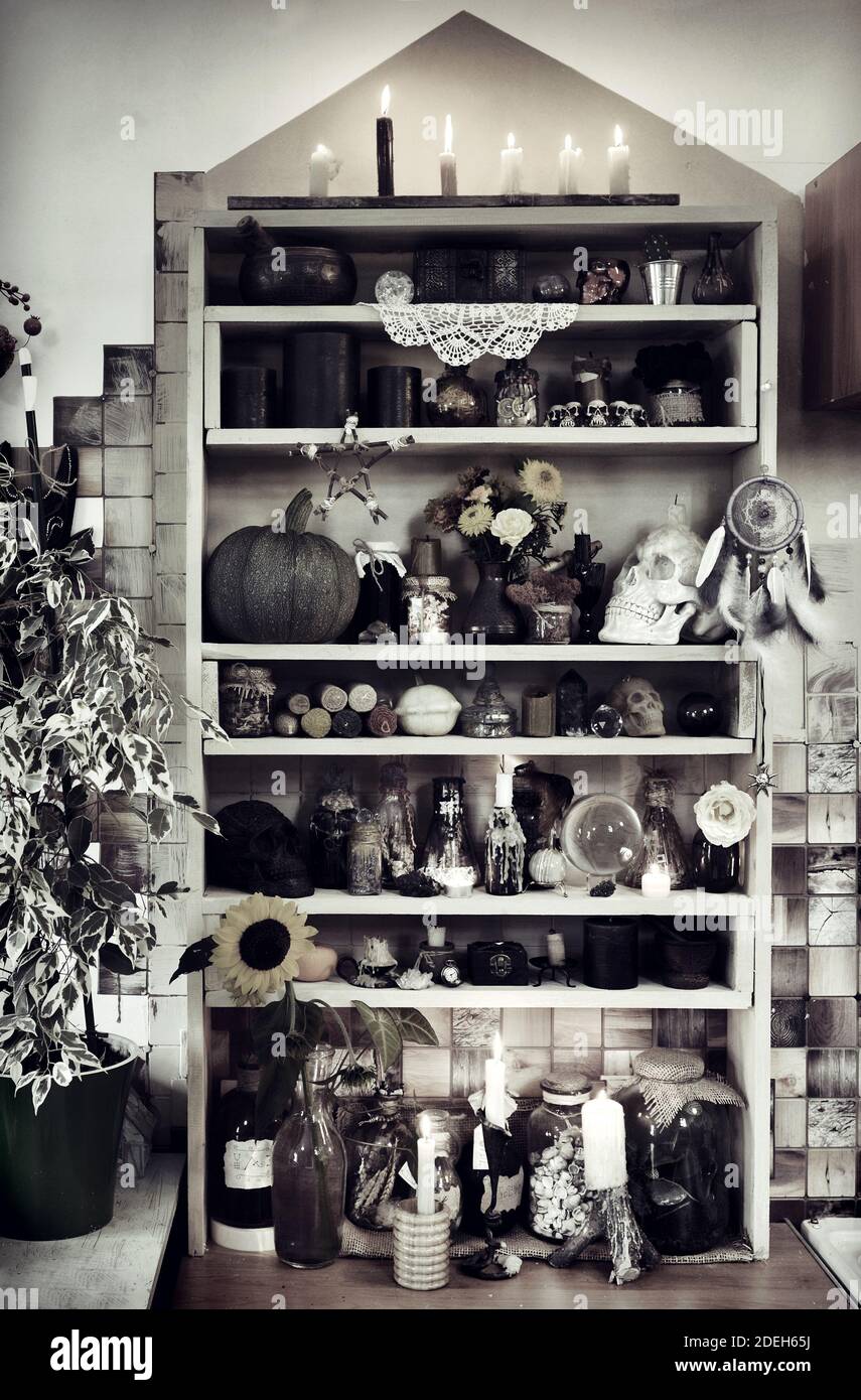 Desaturated styled still life with bottles, crystals, magic objects and ...