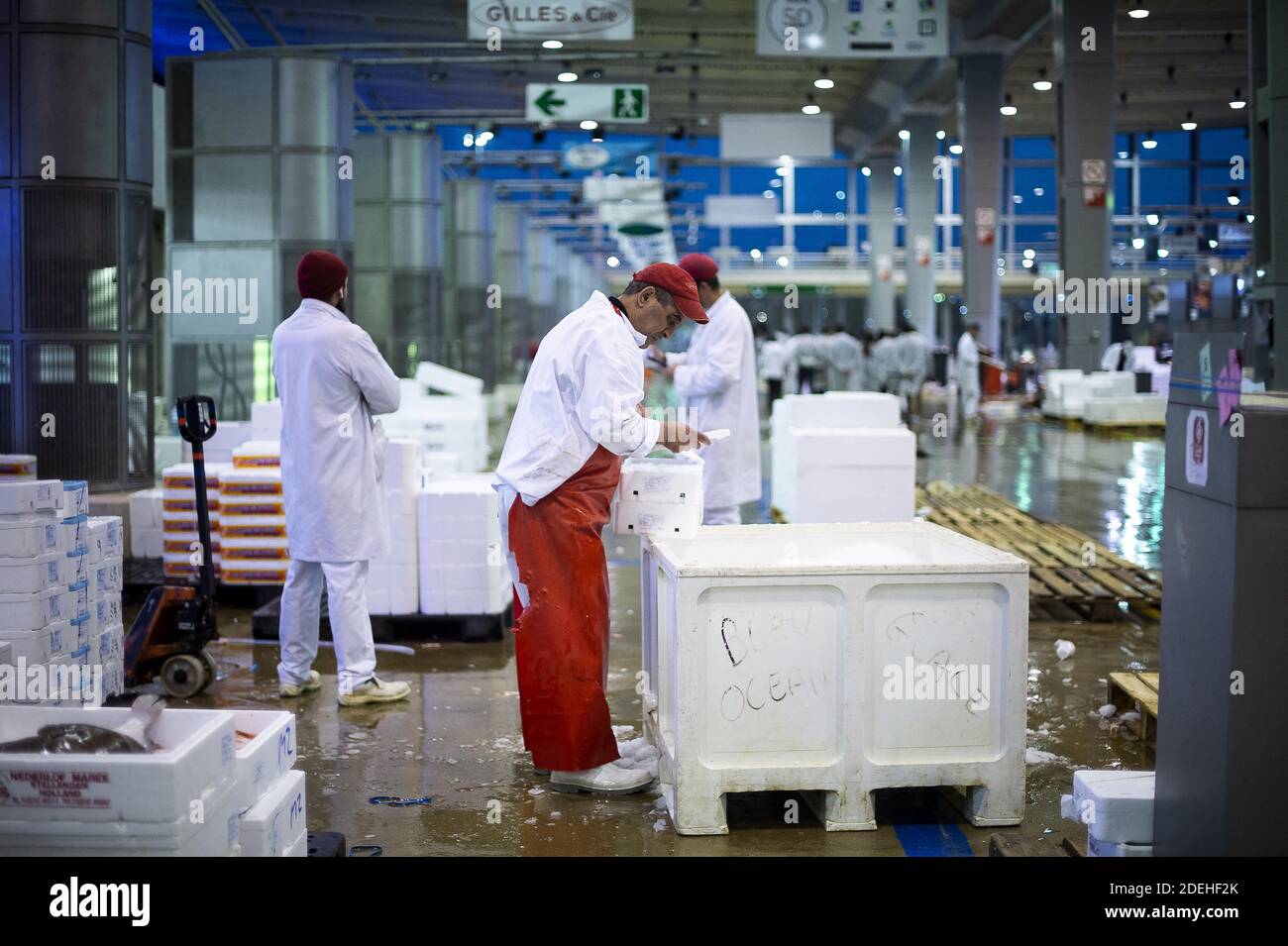A man stands at the seafood area of the international food market of ...