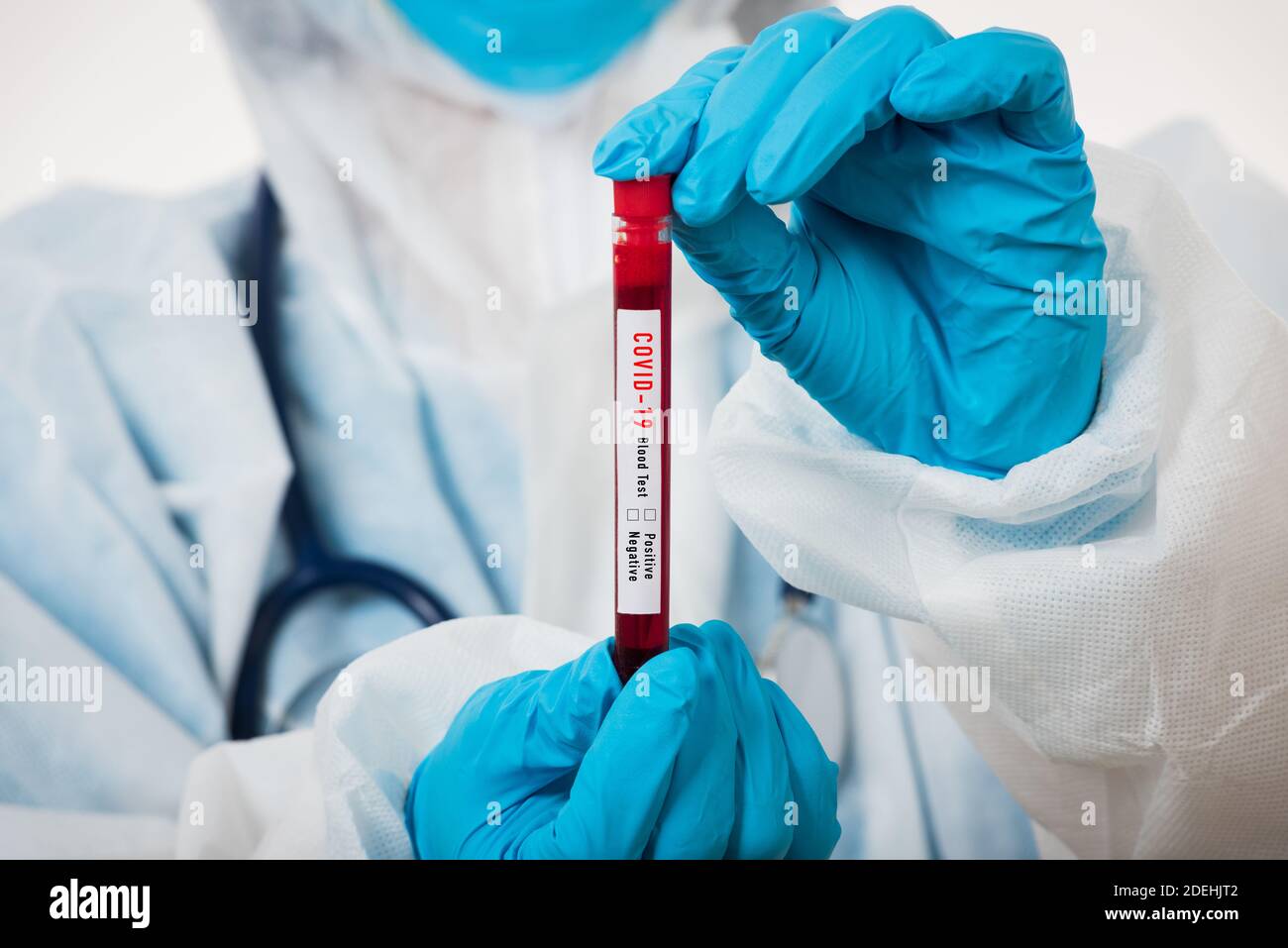 Medical scientist in PPE uniform wear a mask holding test tube ...