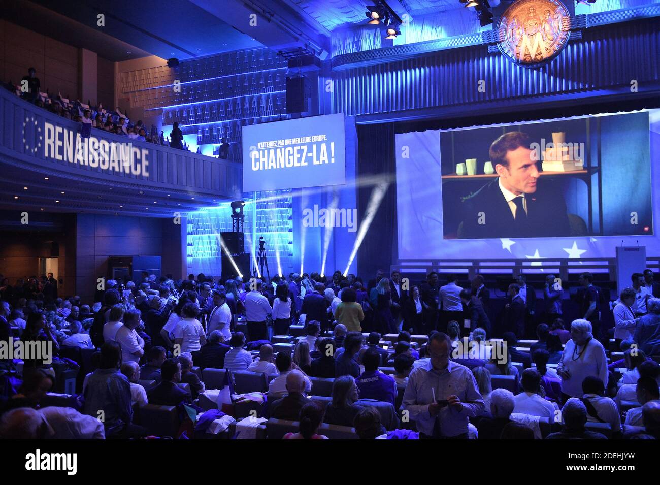 People watch the interview of French president Emmanuel Macron given by ...
