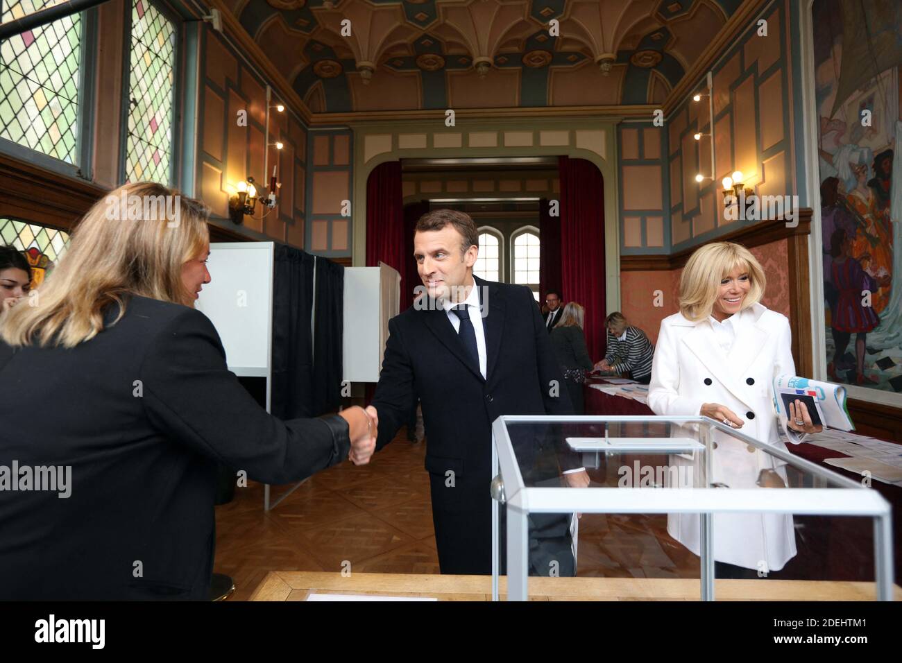 French president Emmanuel Macron casts his ballot at a polling station ...