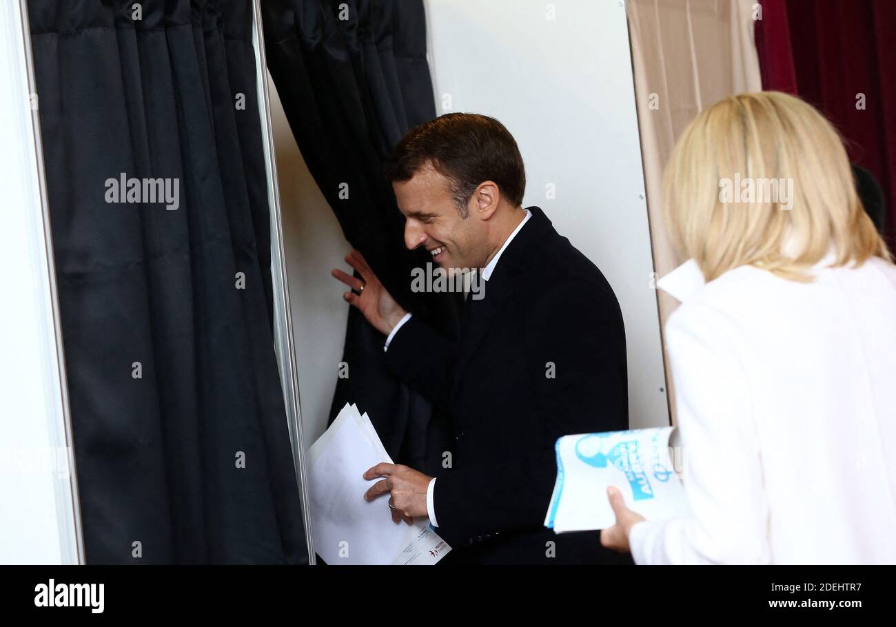 French president Emmanuel Macron casts his ballot at a polling station ...