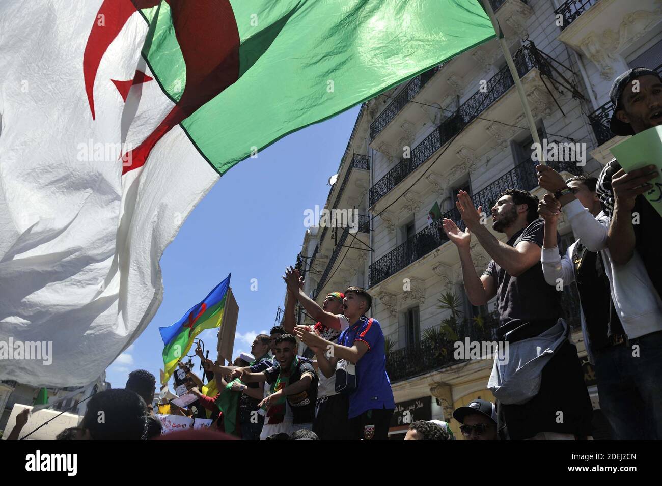 Algerian Protesters March With A Giant National Flag During A