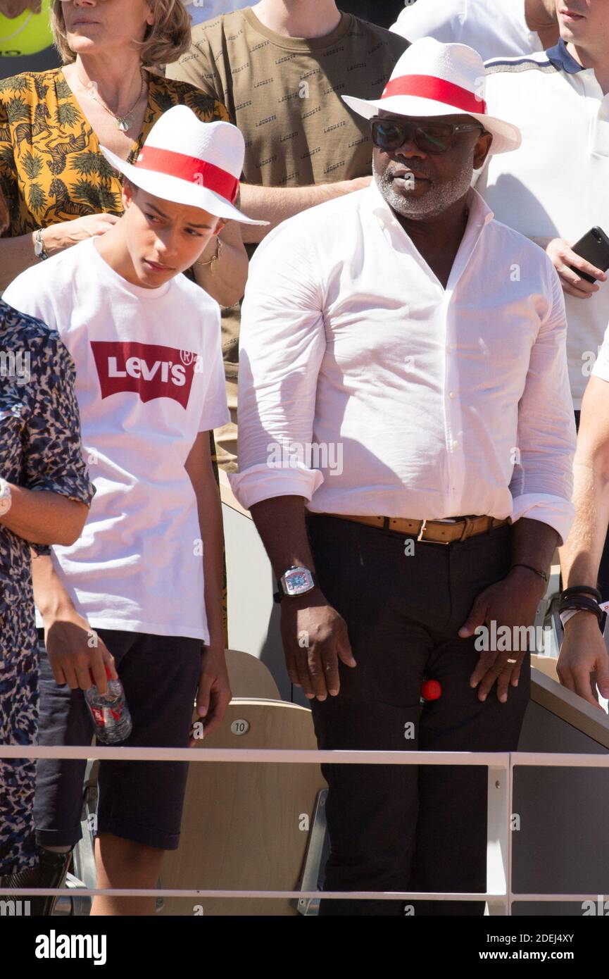 Basile Boli and his nephew Thomas in stands during French Tennis Open ...