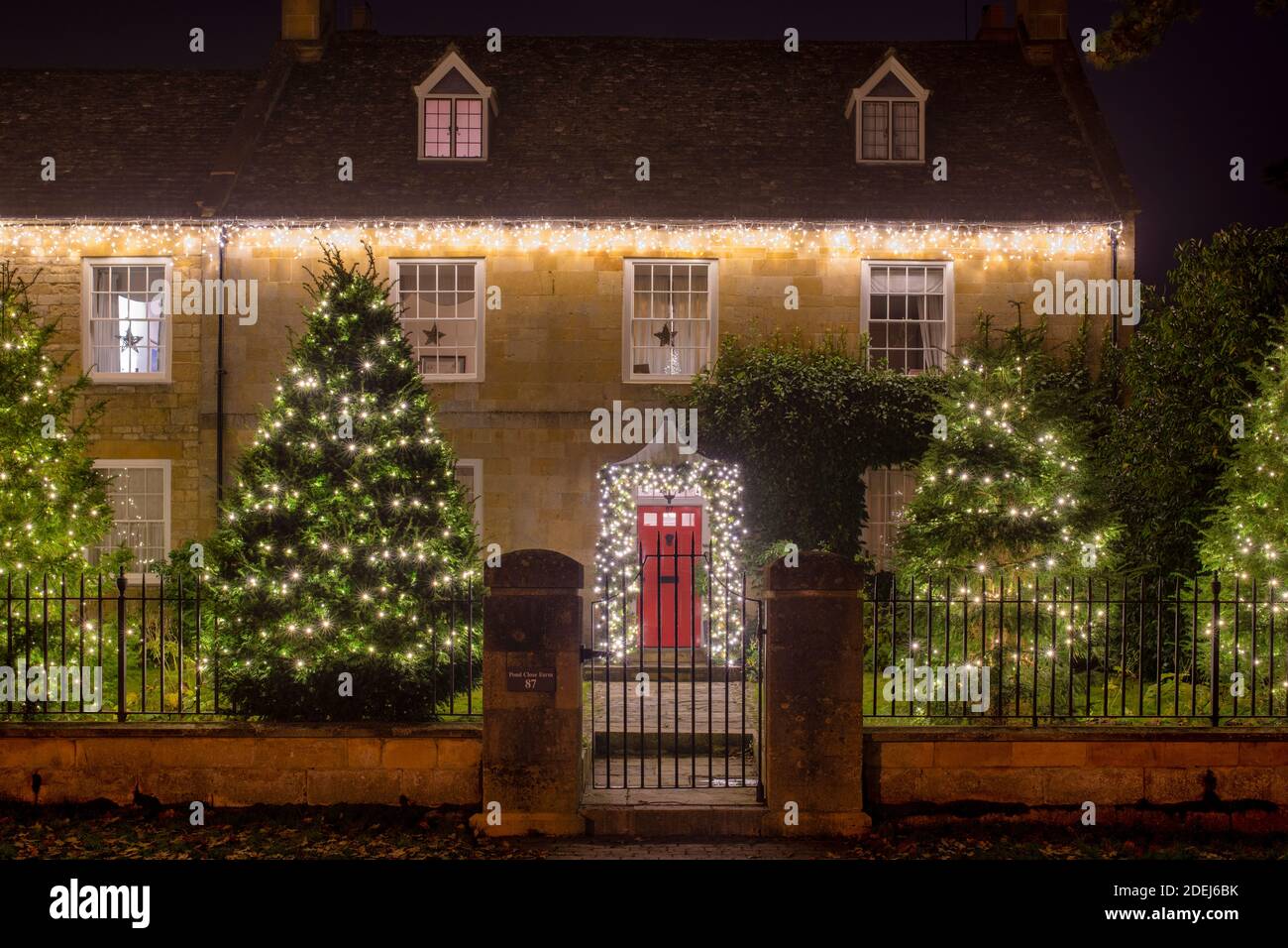 Large house and garden christmas tree decorations in broadway at night ...
