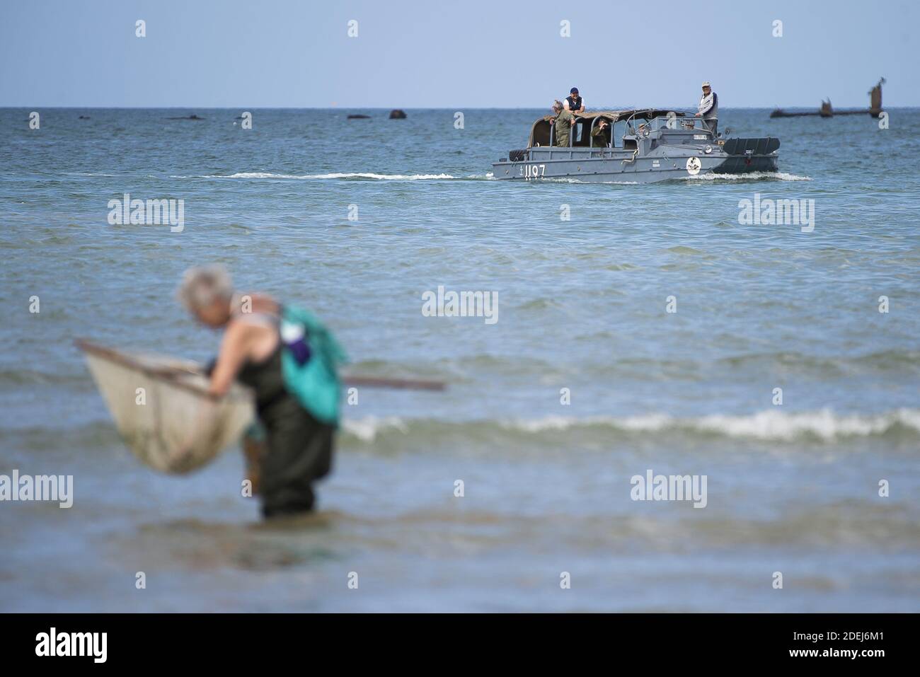 Shrimp fisherman with old us army amphibious vehicle at Arromanches, in ...