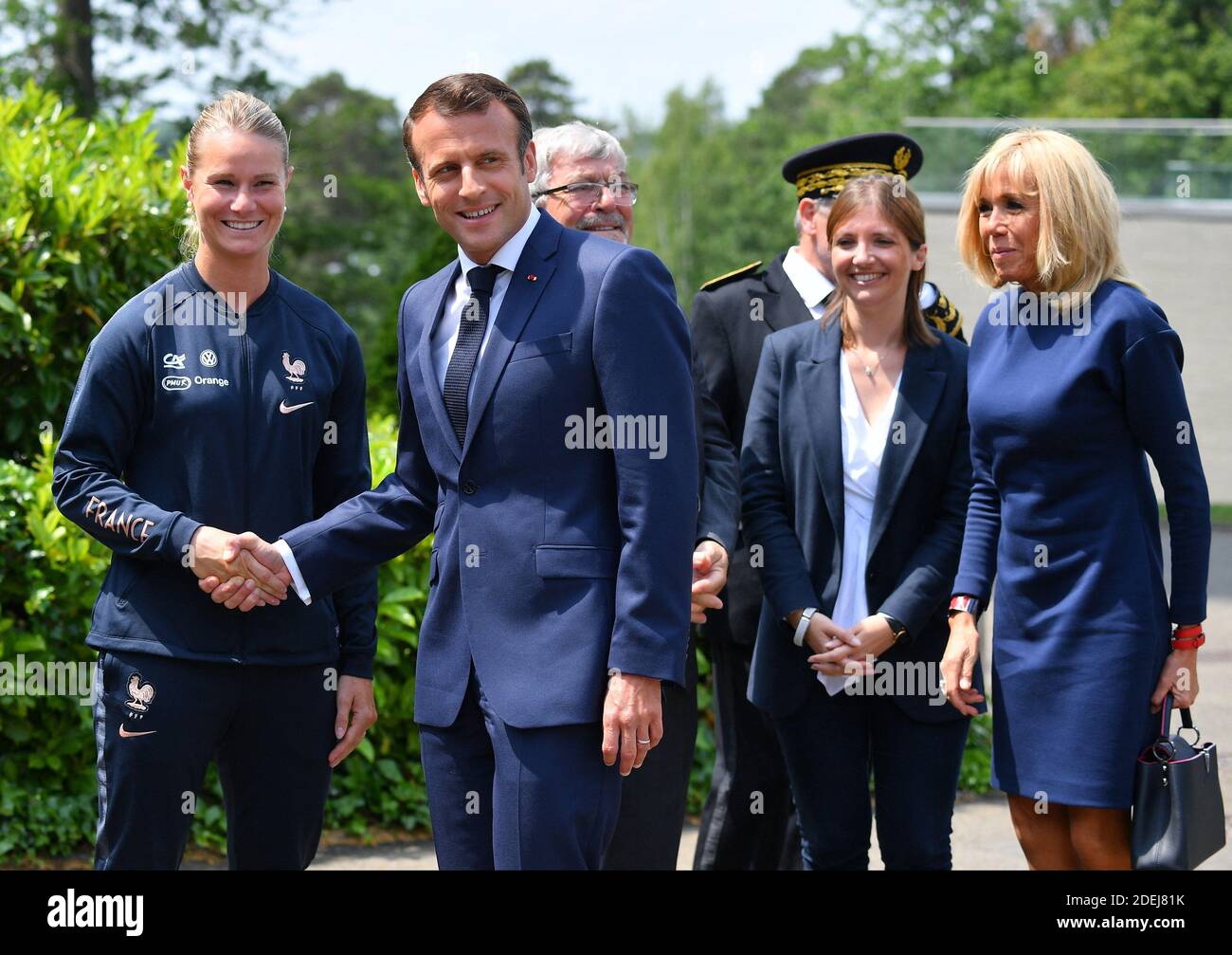 French President Emmanuel Macron shakes hands with France's midfielder ...