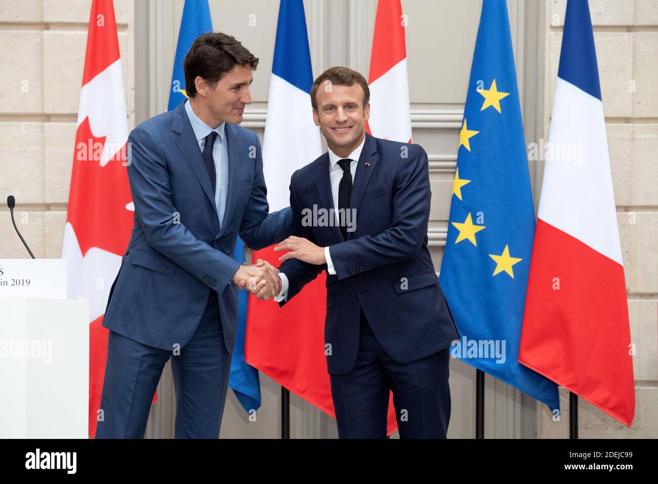 French President Emmanuel Macron shakes hands with Canadian Prime ...