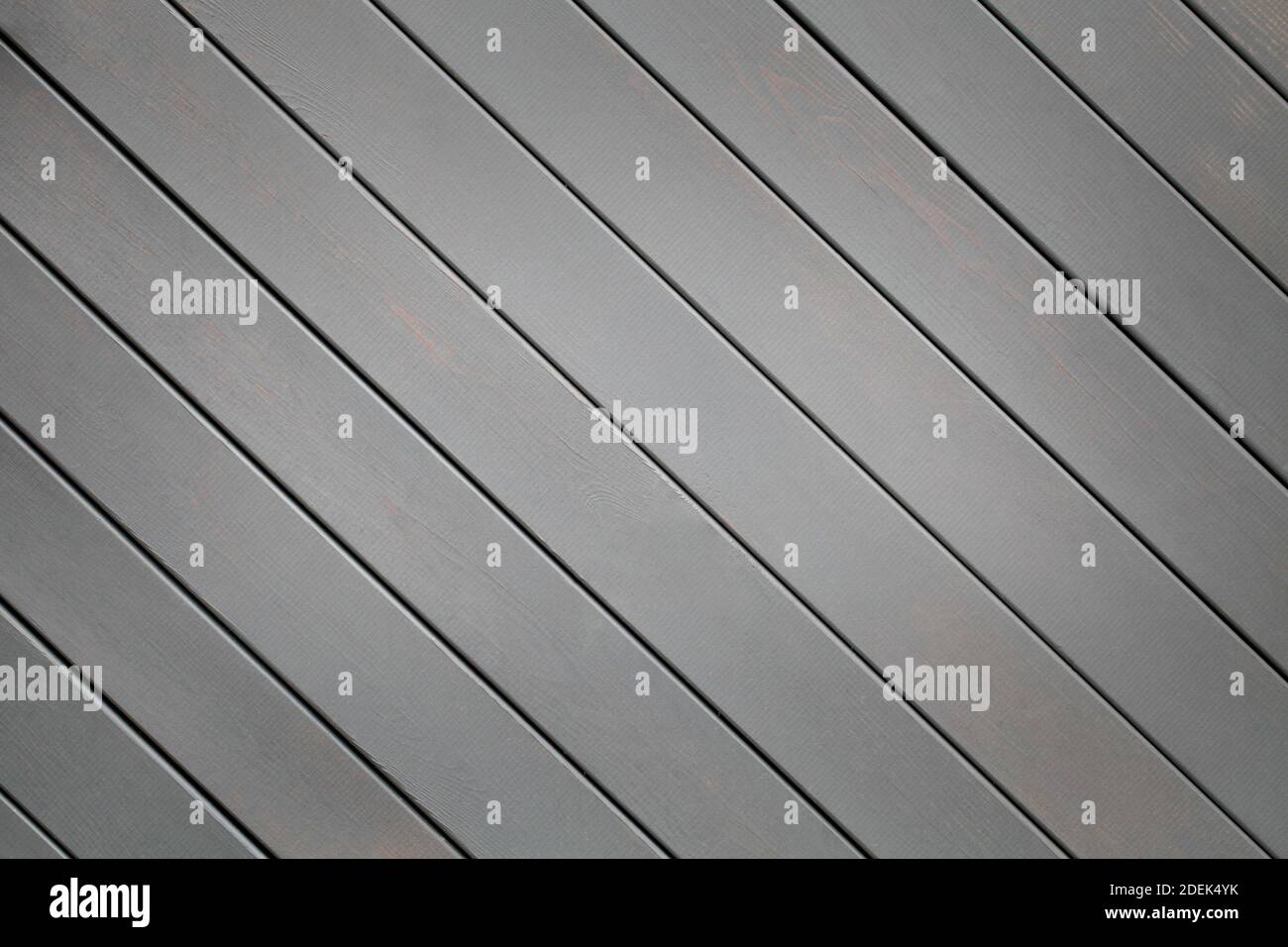 Gray wooden background with diagonal lines. Board background with copy ...