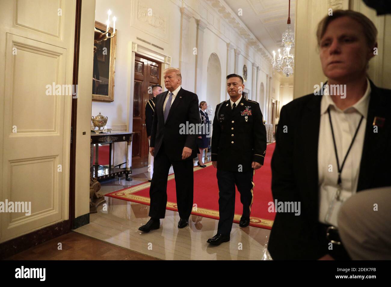 US President Donald Trump walks with Army staff sergeant David G ...
