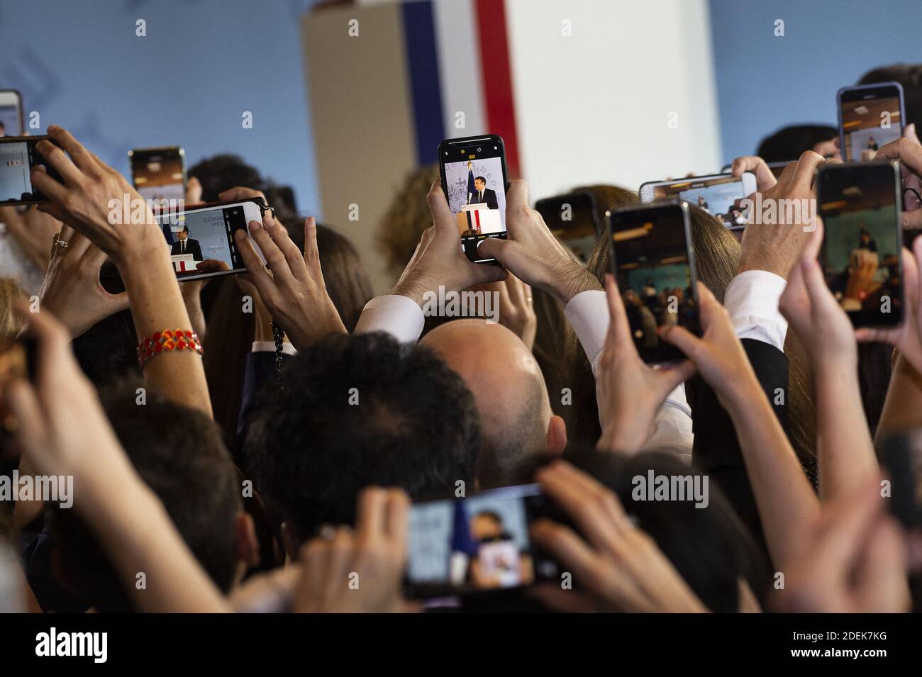 France's President Emmanuel Macron is seen on the screen of a ...
