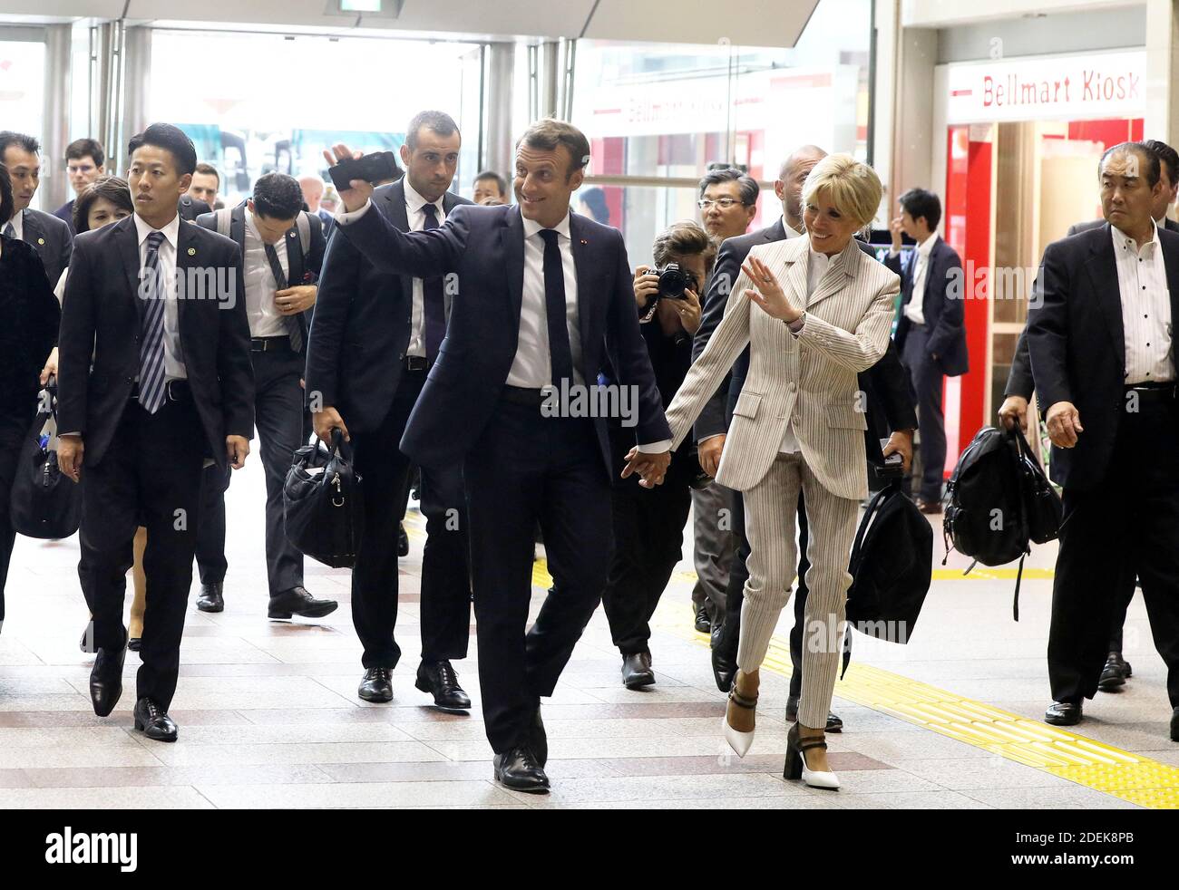 French President Emmanuel Macron and his wife Brigitte Macron walking ...