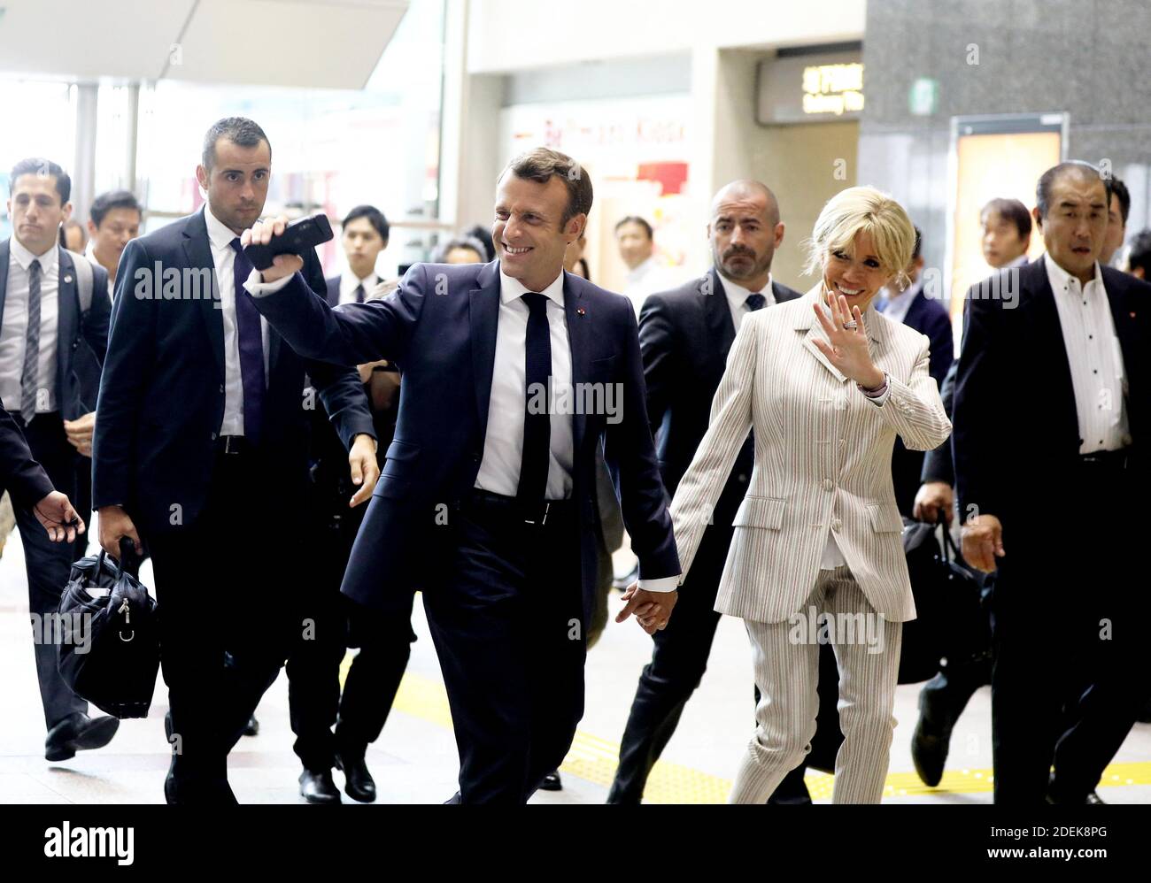 French President Emmanuel Macron and his wife Brigitte Macron walking ...
