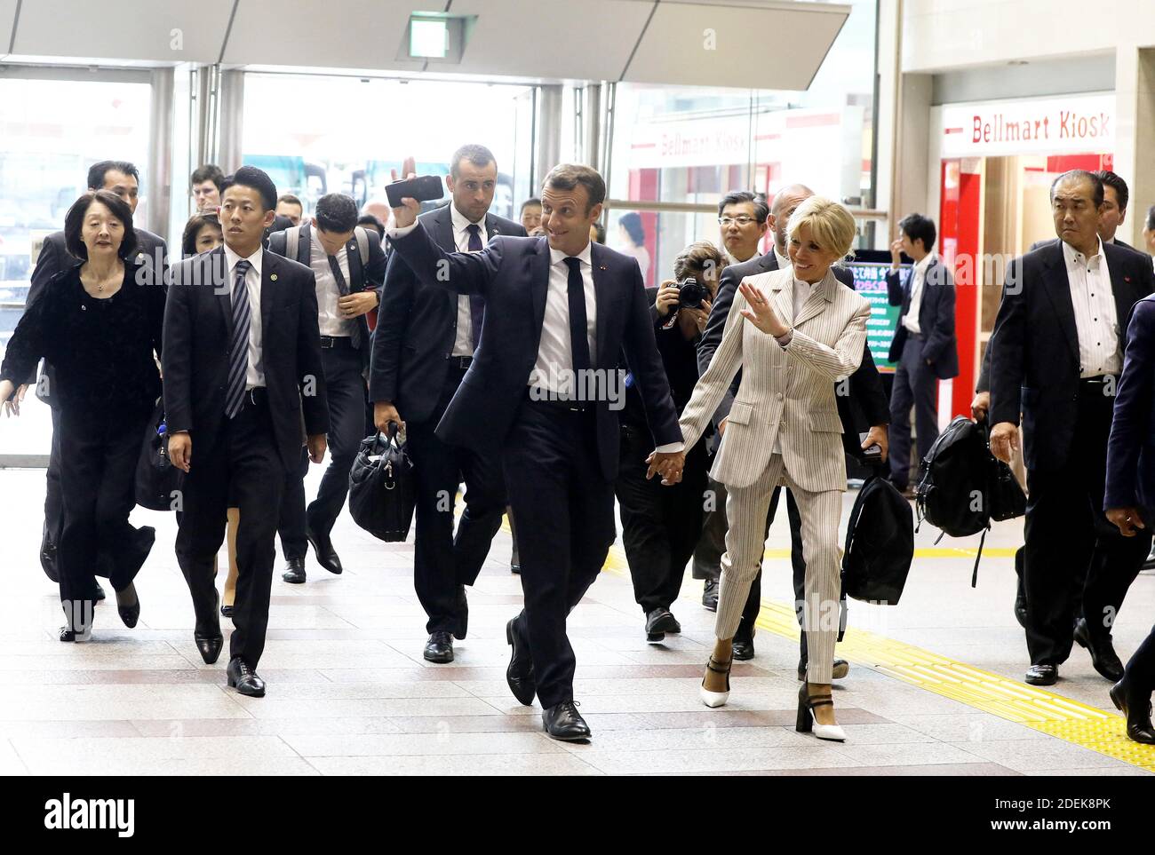 French President Emmanuel Macron and his wife Brigitte Macron walking ...