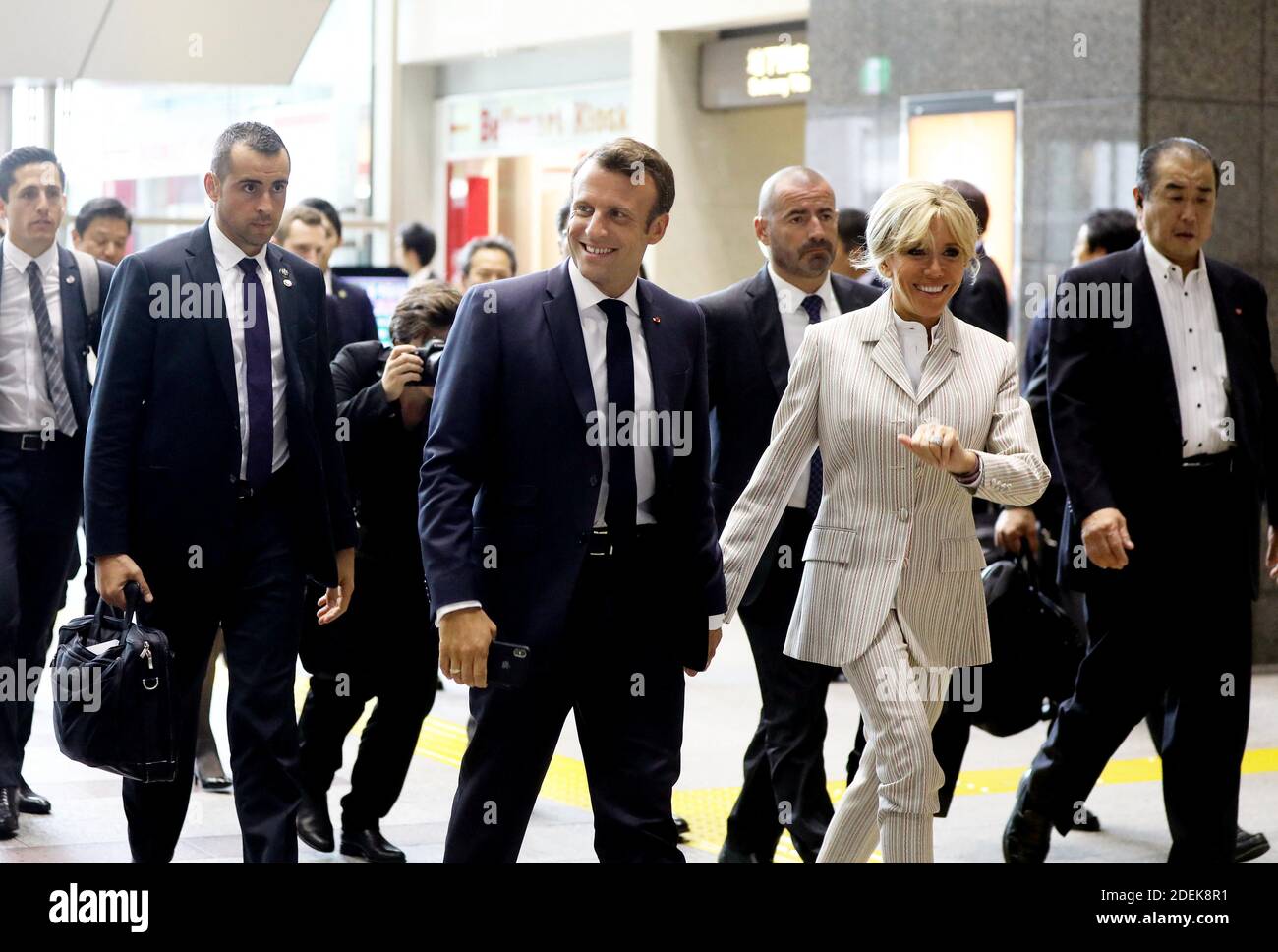 French President Emmanuel Macron and his wife Brigitte Macron walking ...